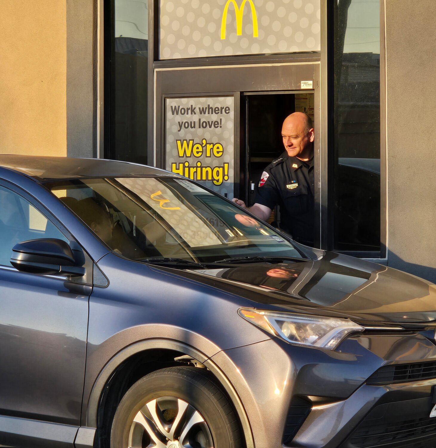 Katy Police Chief Bryon Woytek mans the drive thru and serves coffee at ...